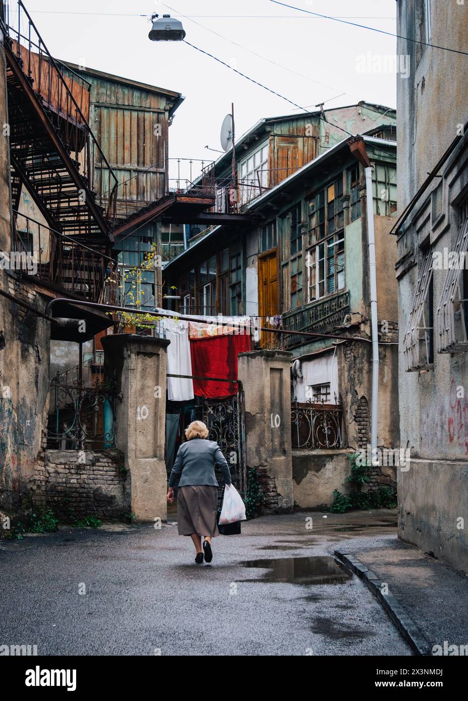 Old lady walking in the street of Tbilisi old town (Georgia ...