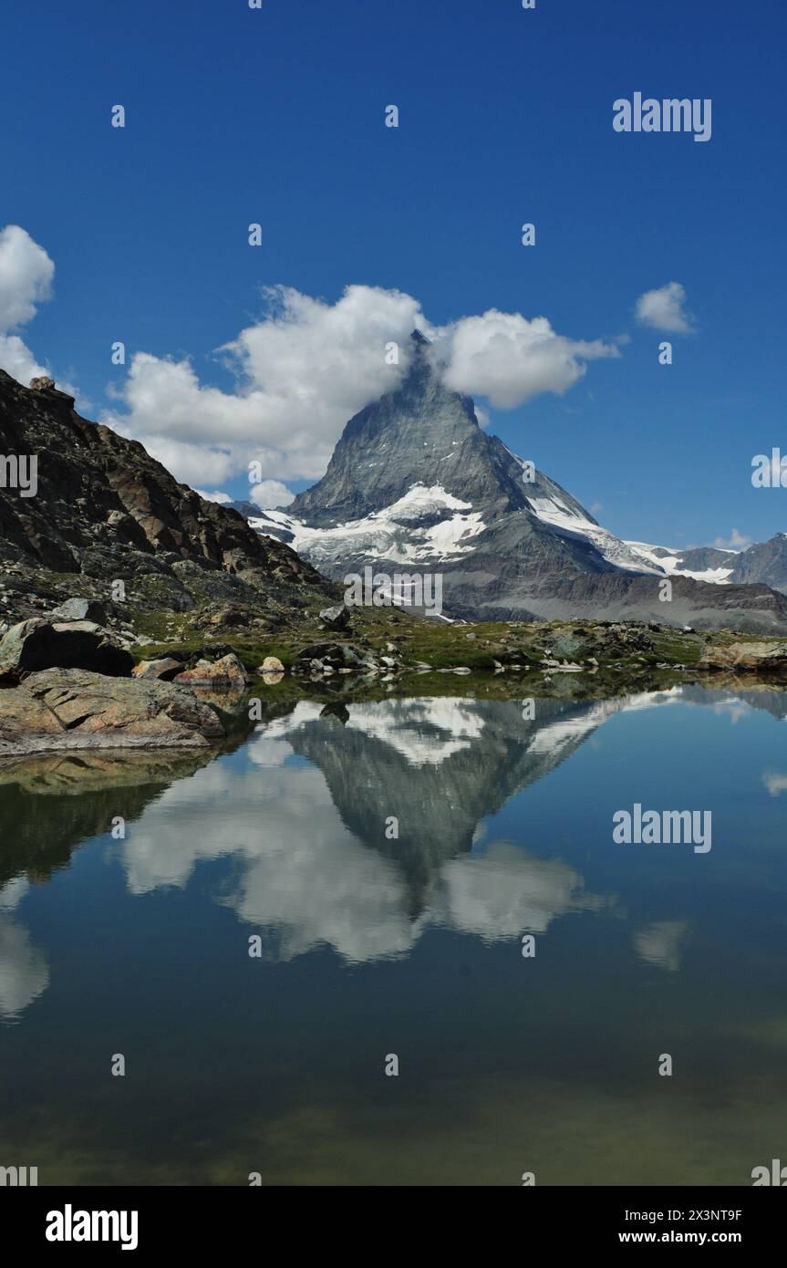 The Matterhorn, Switzerland, with its peak in the clouds and reflecting ...