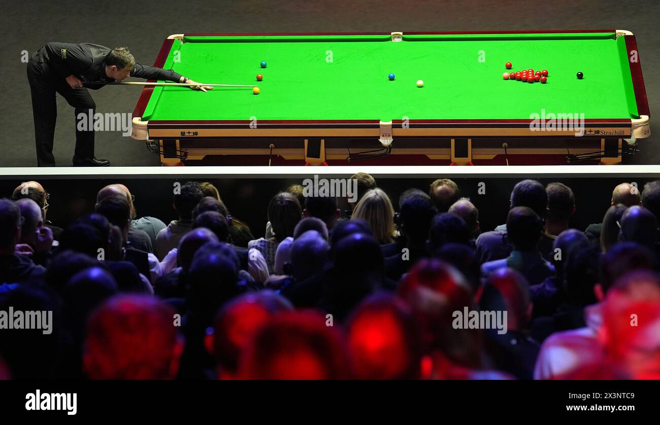 Ronnie O'Sullivan plays a shot during his match with Ryan Day, on day ...