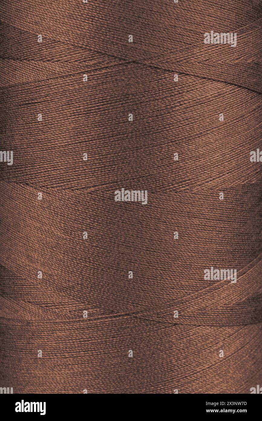Texture of brown color threads in spool close up, macro. Sewing threads ...