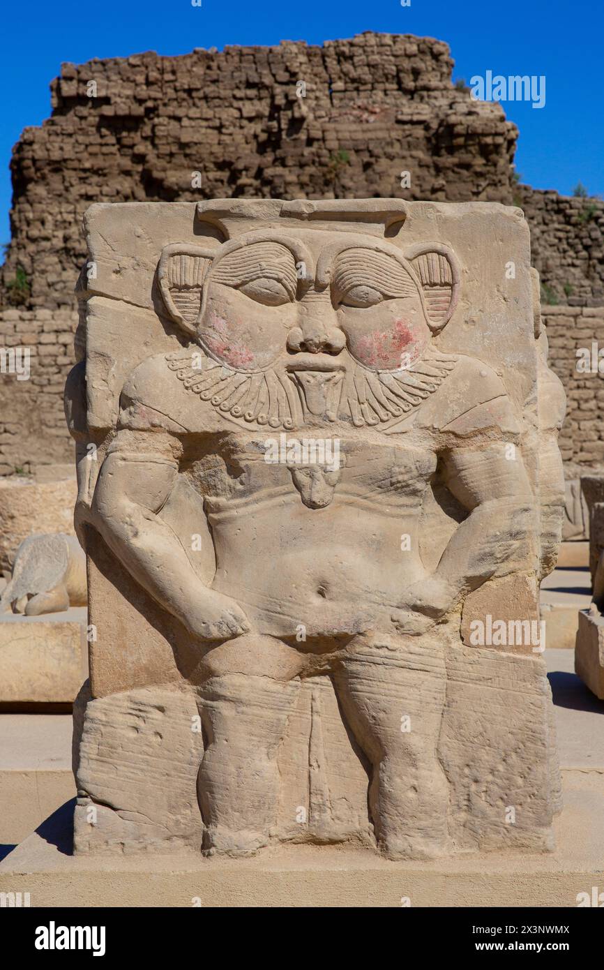 Stone carving of the ancient Egyptian diety Bes at the Dendera Temple ...