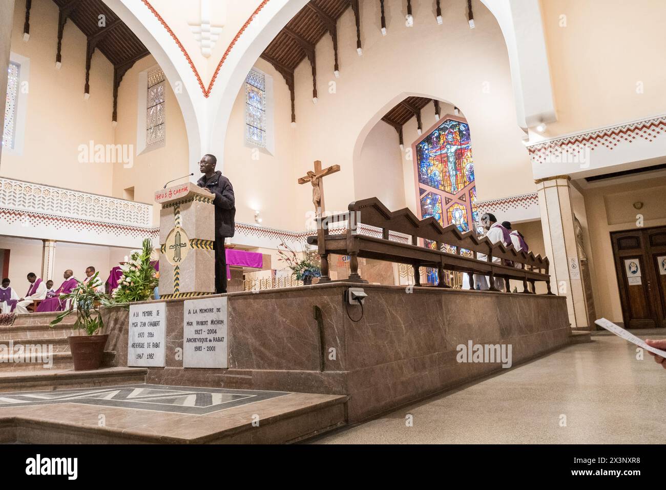 A young Catholic speaks from the pulpit in the interior of the ...