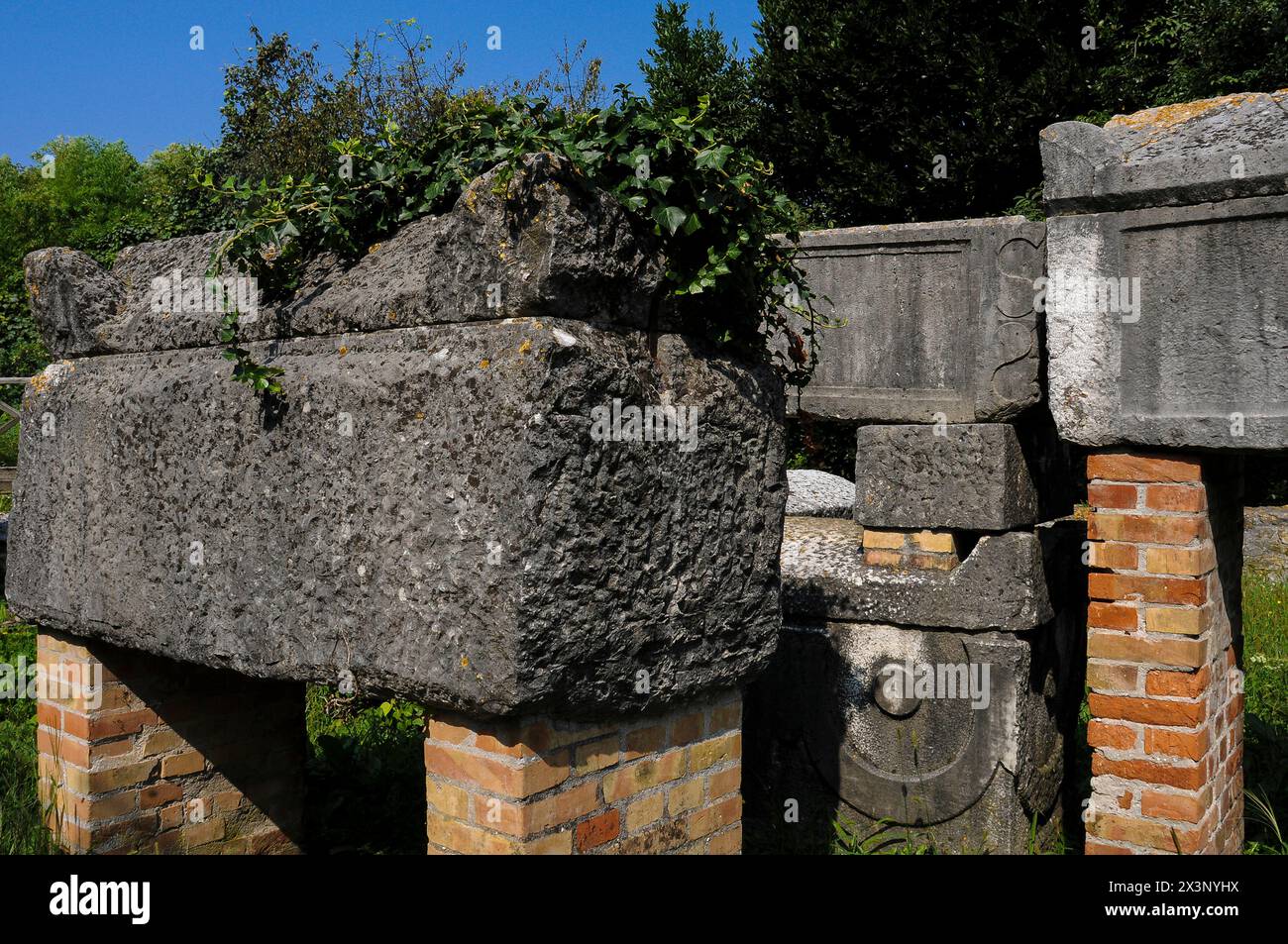 Sarcophagi resting on modern brick pillars. Amid family monuments of ...