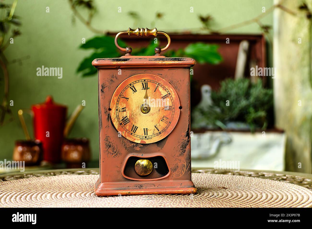 Antique rusty clock with pendulum on vintage background in the garden ...