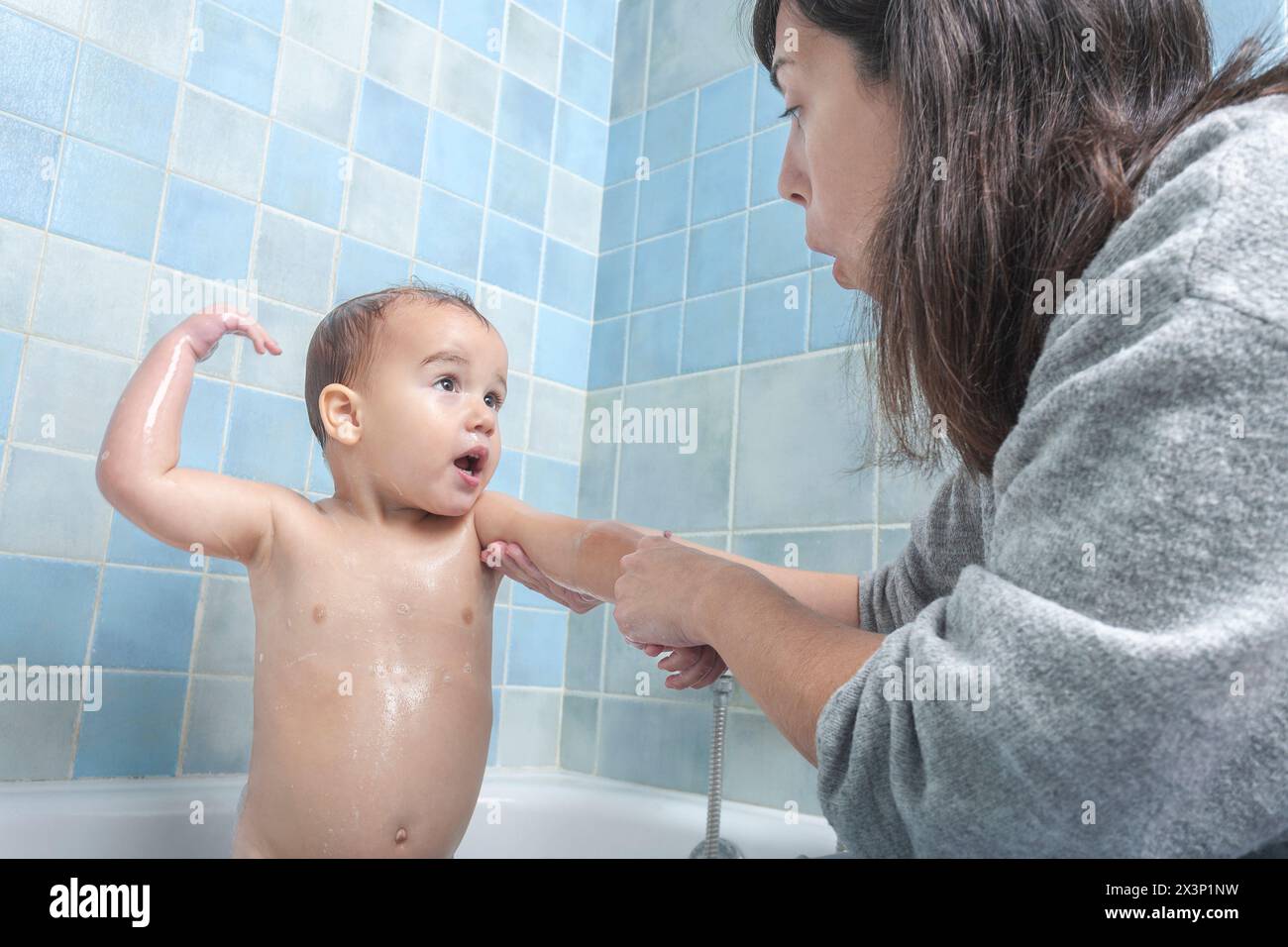 mother showering her son in the bathtub Stock Photo - Alamy
