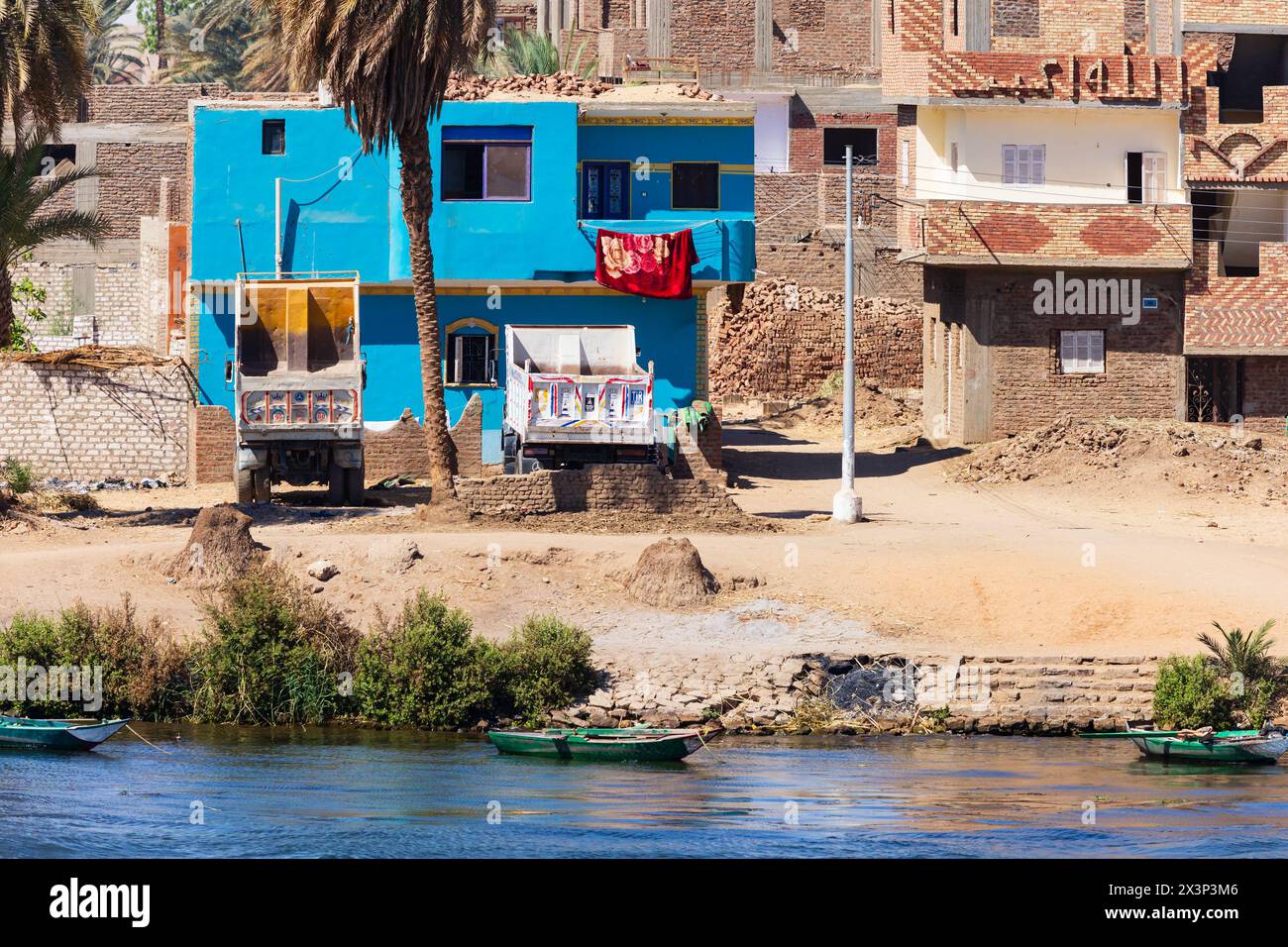 Colourful homes on the West bank of the River Nile, Aswan, Edfu, Egypt ...