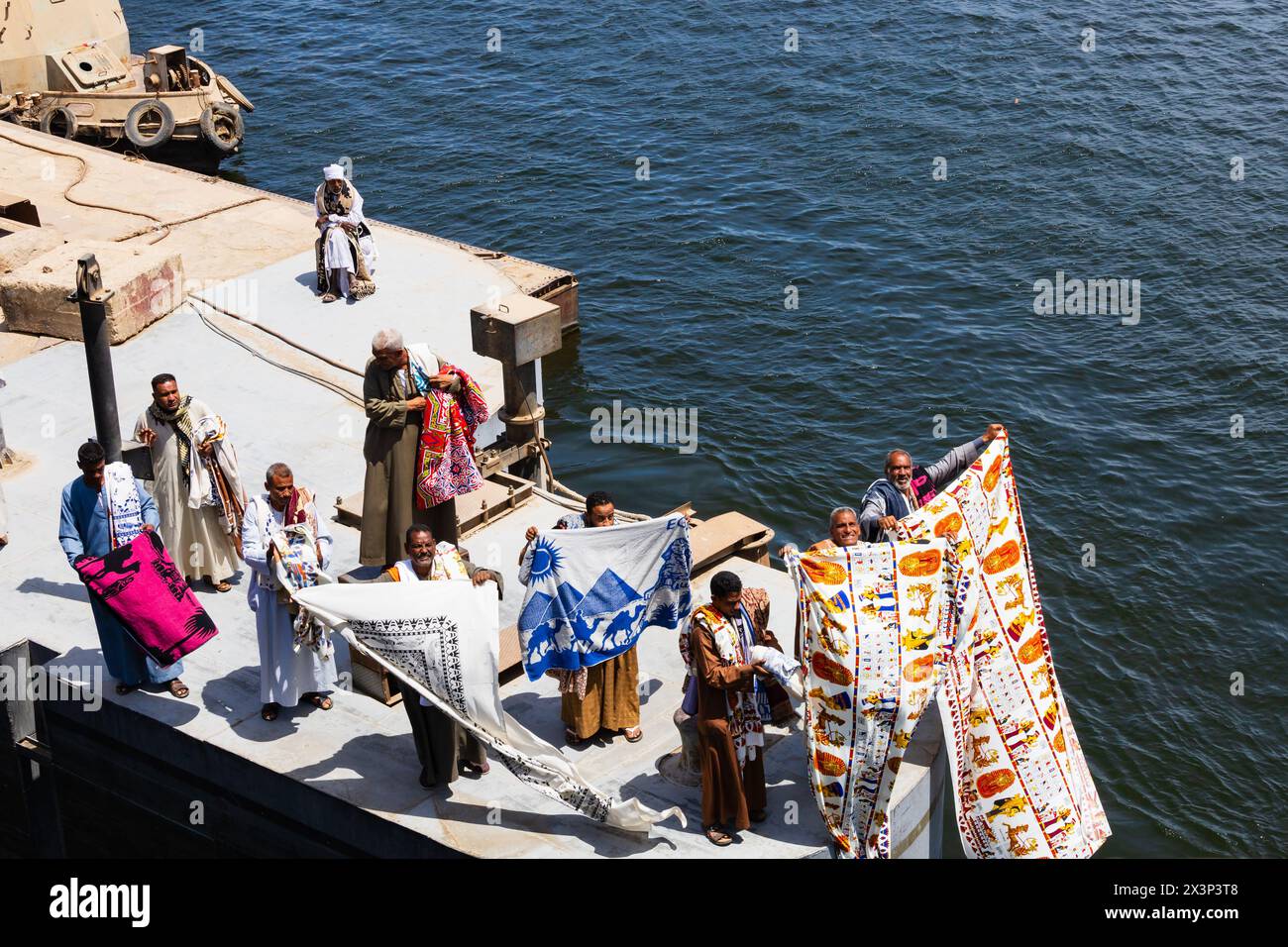 Selling towels to tourists on Nile cruise ships at Esna lock on the Old ...