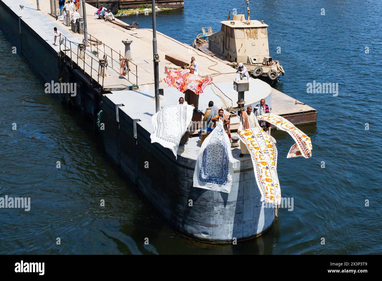 Selling towels to tourists on Nile cruise ships at Esna lock on the Old ...