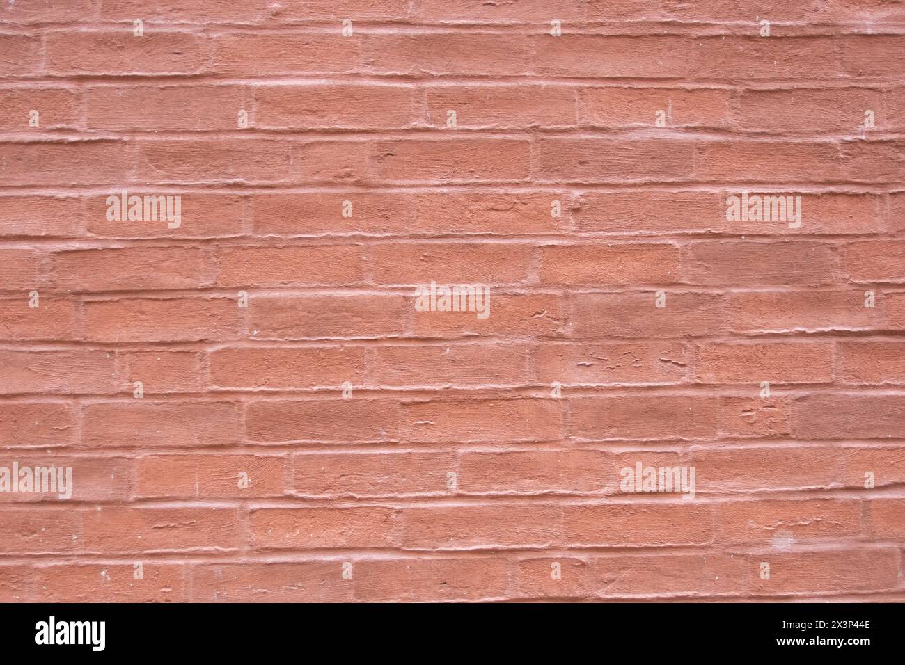 Red structural stone wall of the ancient building consists of old ...