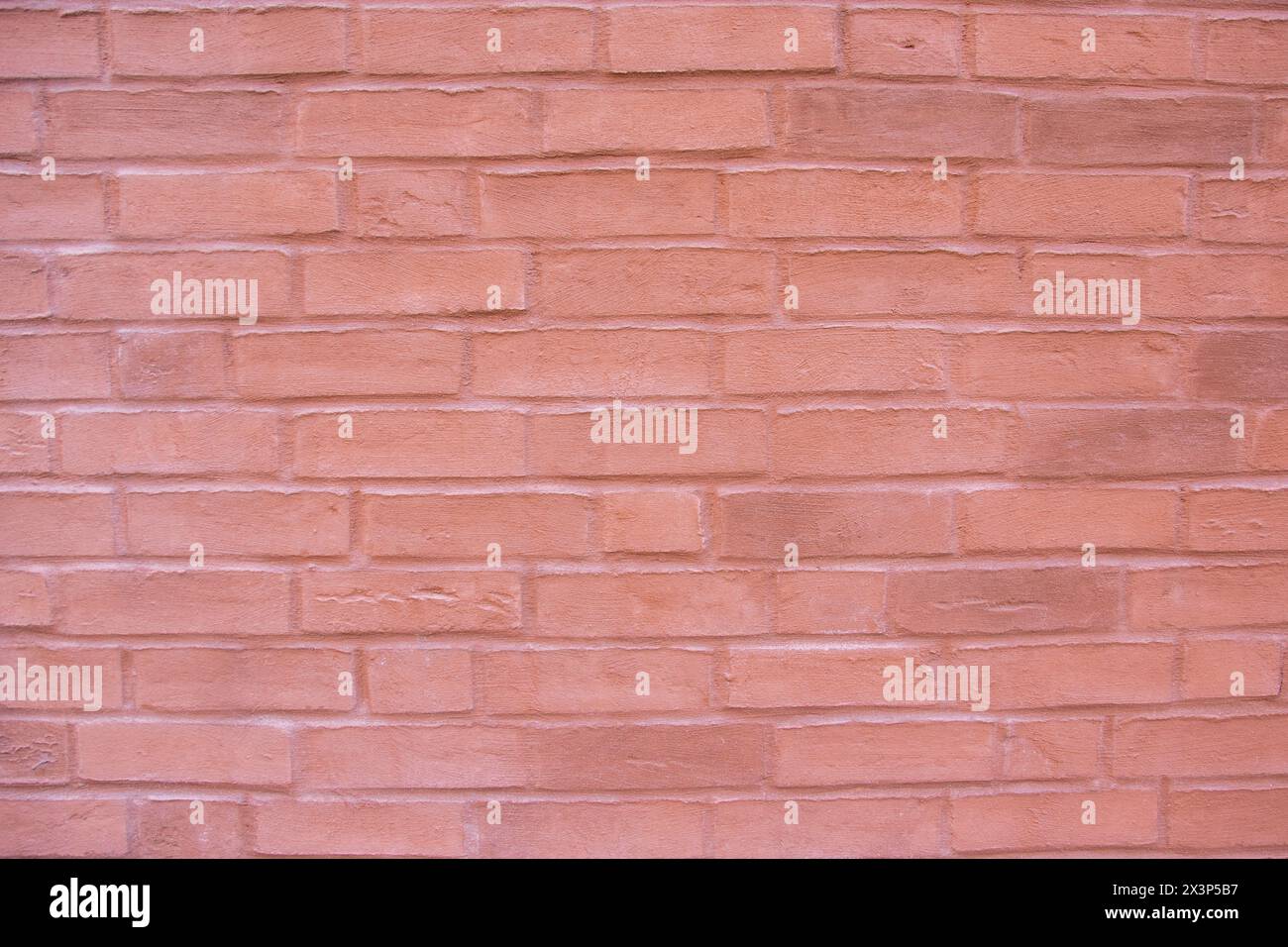 Structural stone wall of the modern building consists of red little ...