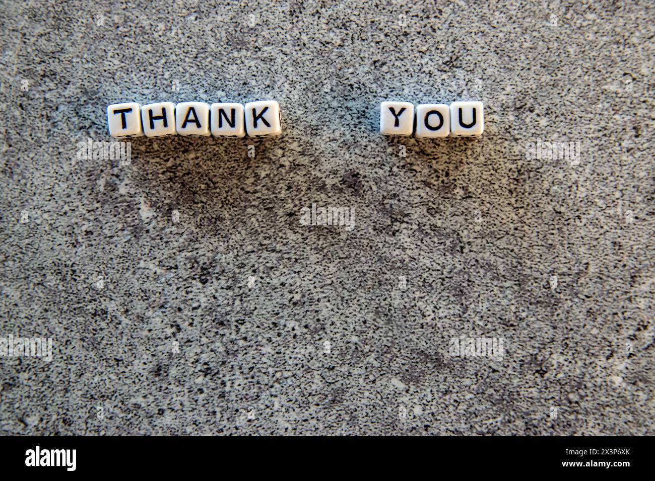 Thank you exclamation word on the stone background Stock Photo - Alamy
