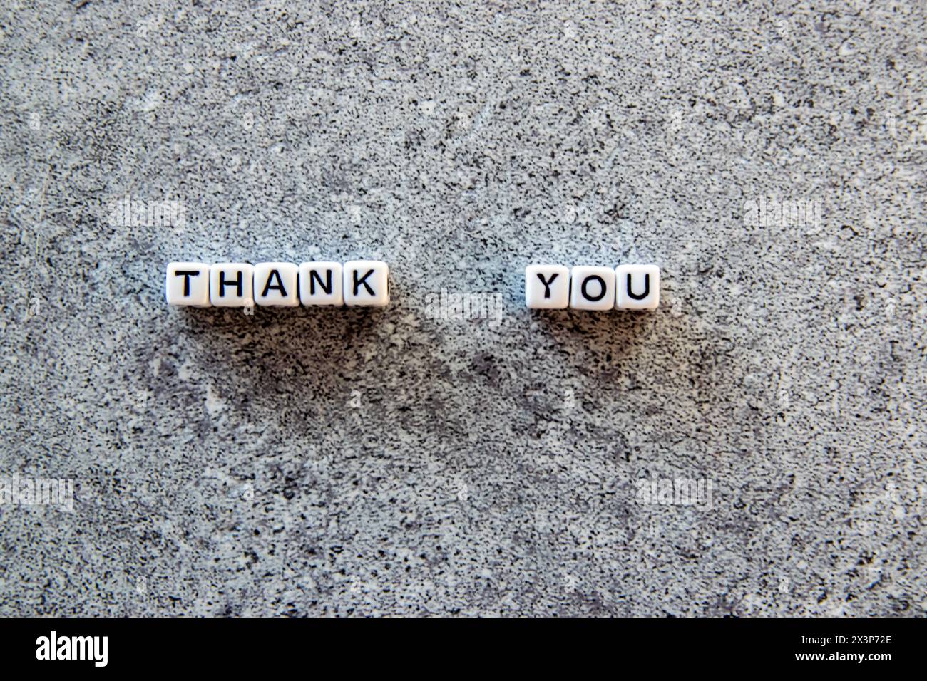 Thank you exclamation word on the stone background Stock Photo - Alamy