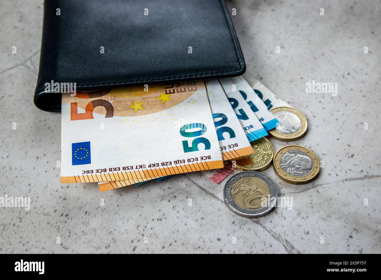 Black partmone with european money. Wallet with bills and coins for ...