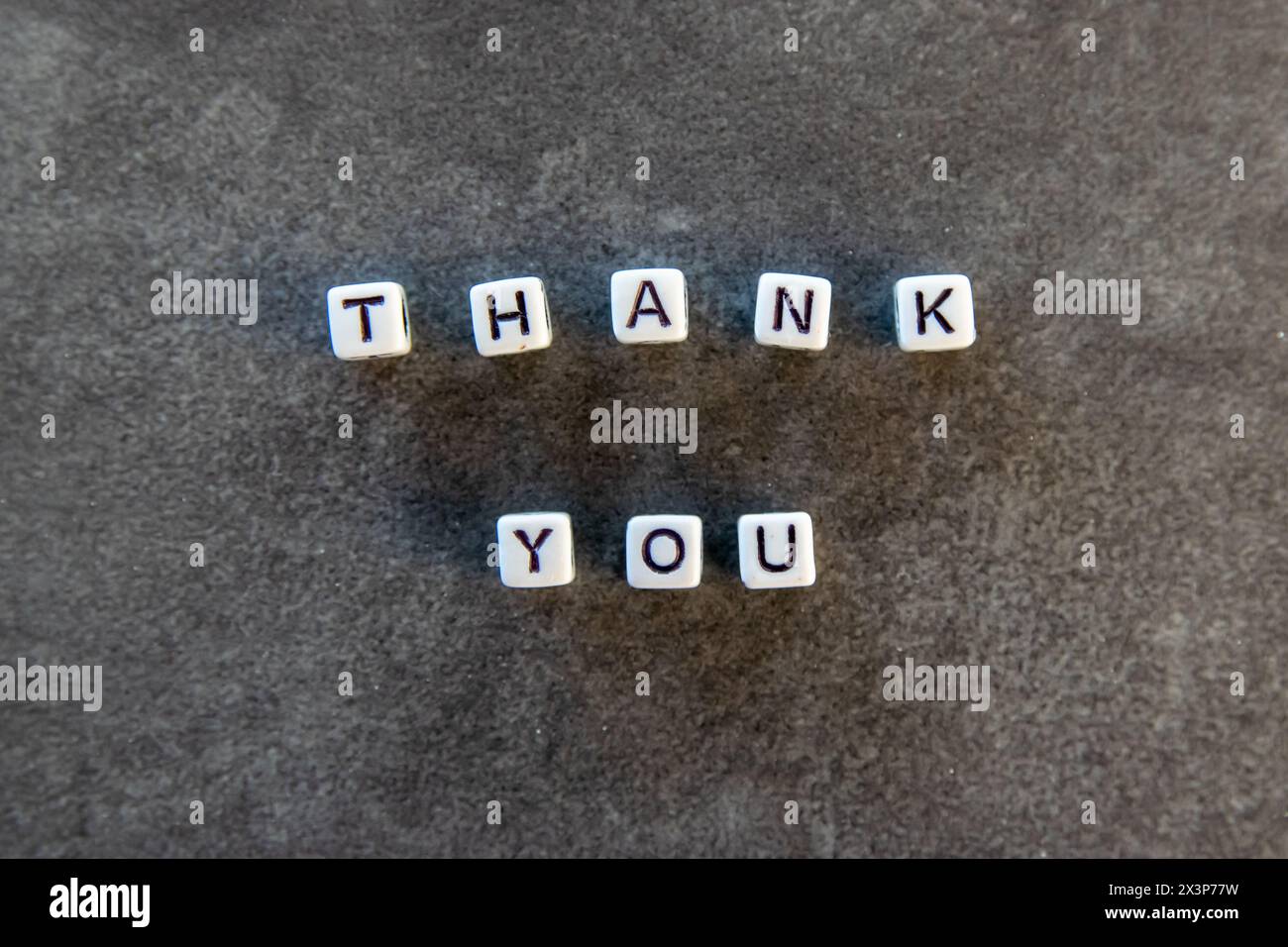 Thank you exclamation word on the stone background Stock Photo - Alamy
