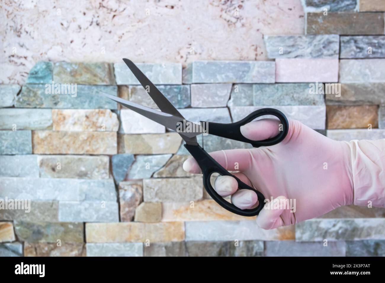 Scissors in the hand with rubber glove. Steel shears for cutting Stock ...