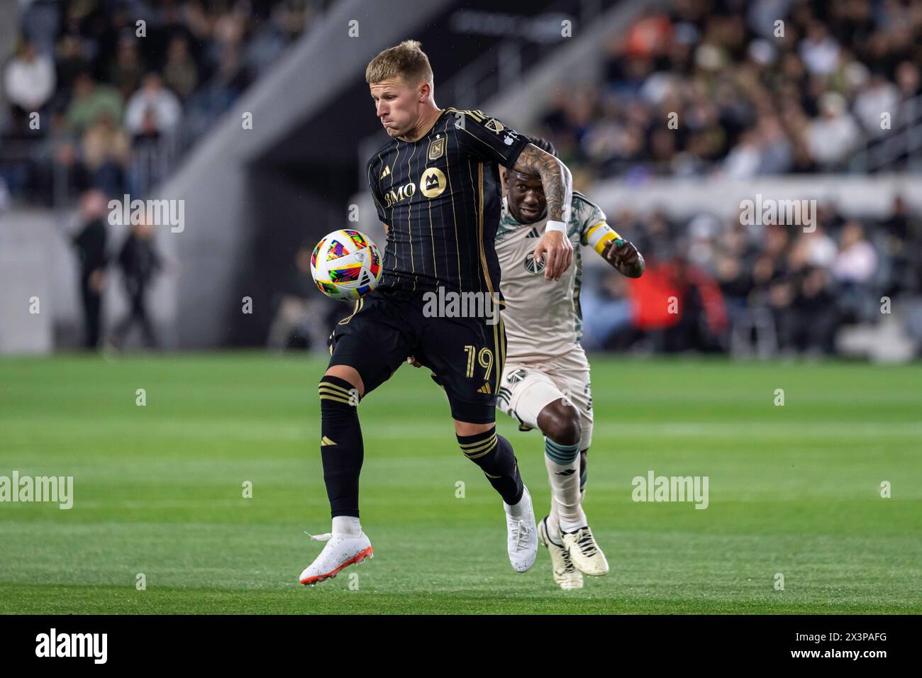 LAFC midfielder Mateusz Bogusz (19) controls possession during a MLS match against the Portland ...