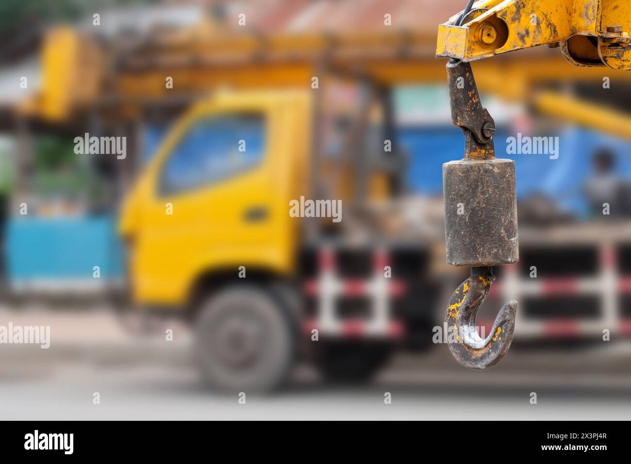 old cranes hooks hanging over crane truck background Stock Photo - Alamy