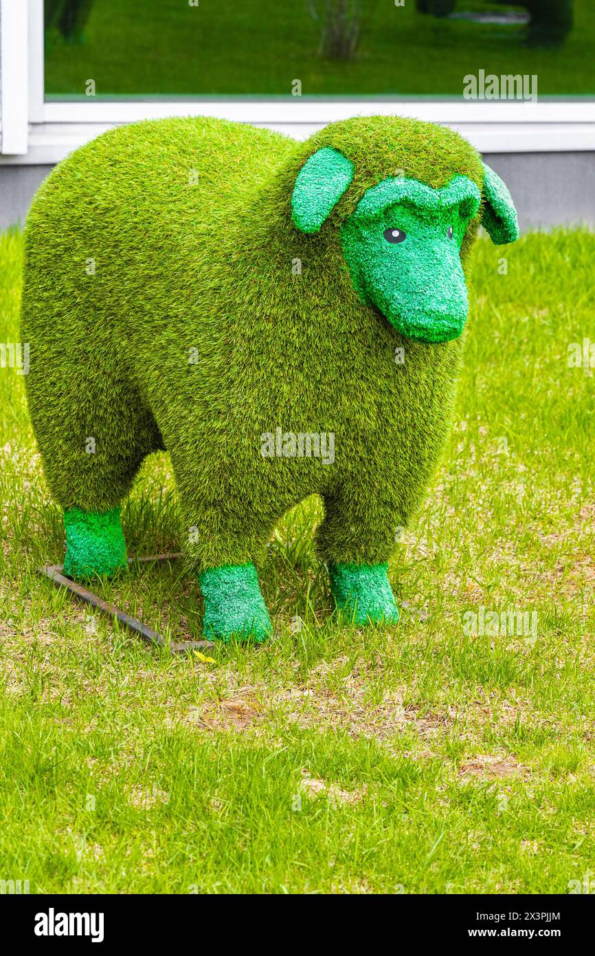 landscape figure of a sheep standing on the lawn. topiary figure of a ...