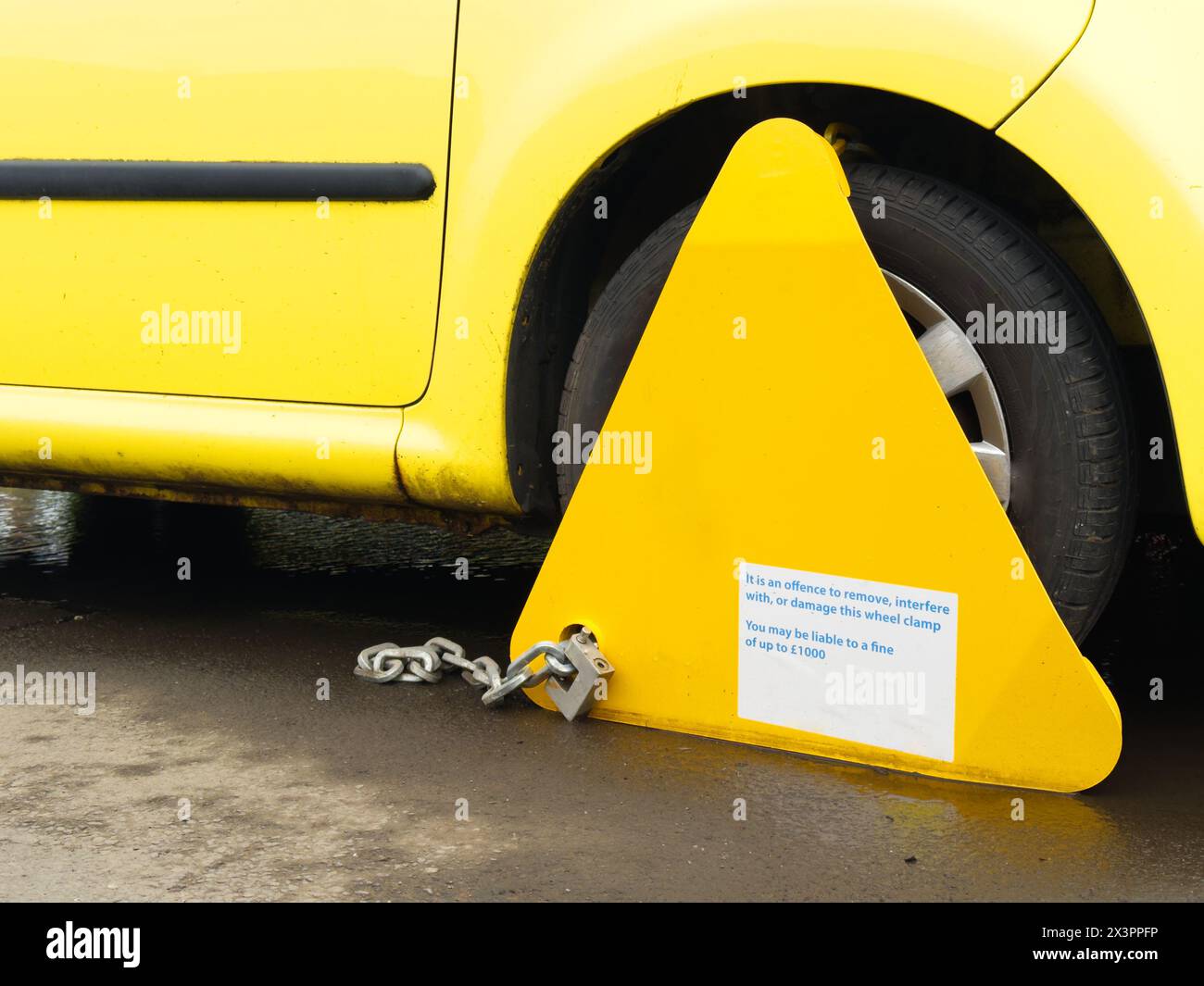Car wheel clamped at restricted parking area Stock Photo - Alamy