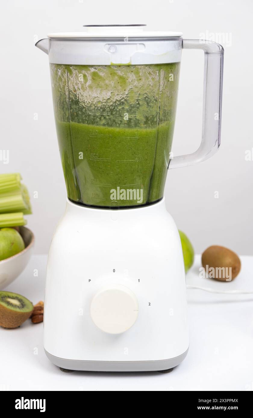 Cooking vegetable fruit smoothie in blender, process of grinding ...