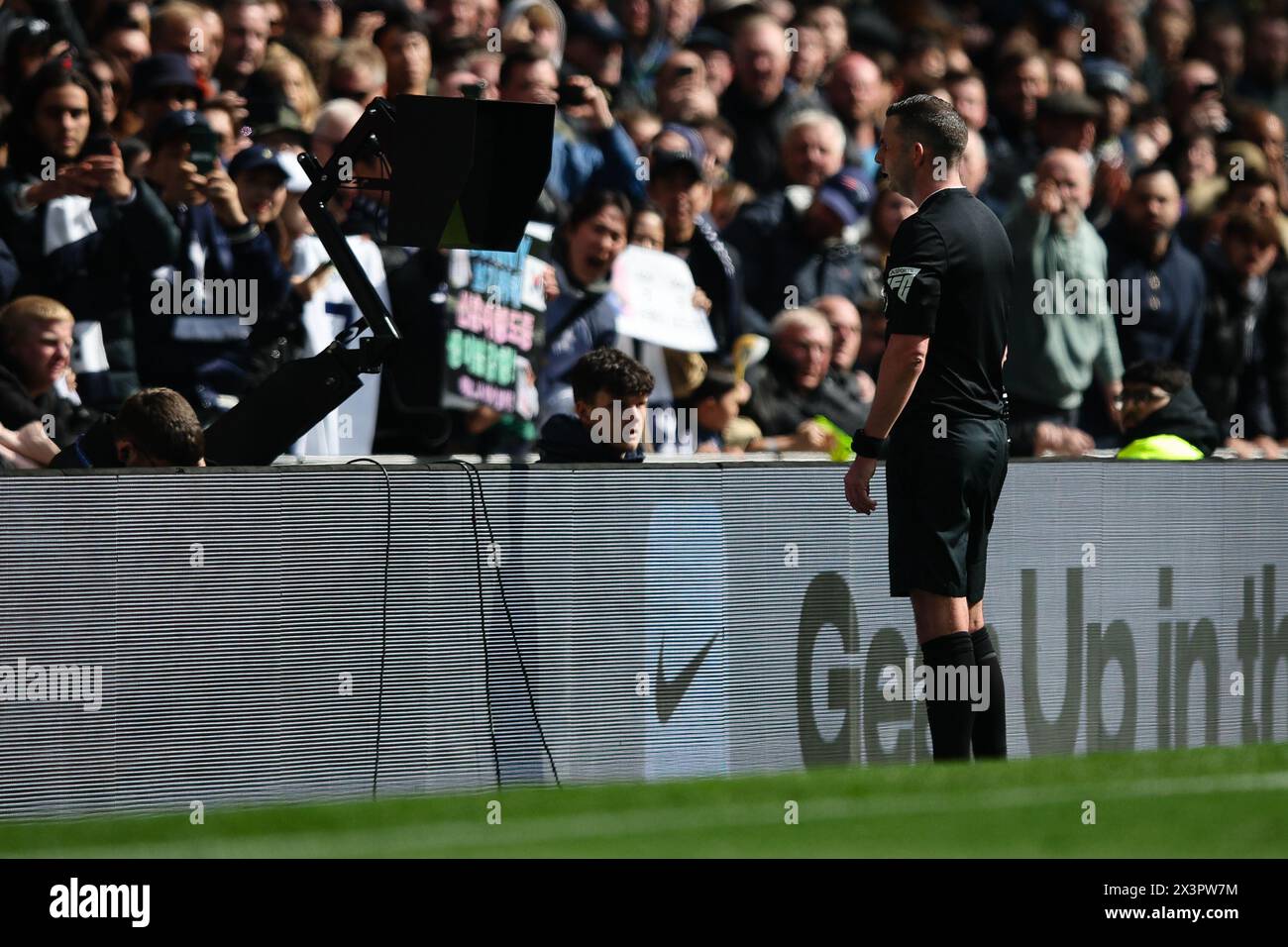LONDON, UK - 28th Apr 2024: Referee Michael Oliver consults the VAR ...