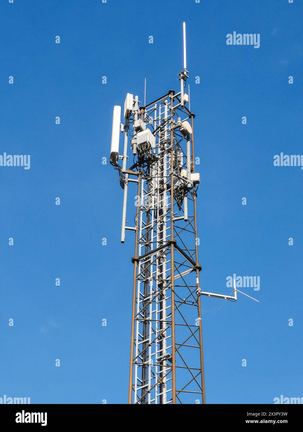 A telecommunication tower with different kinds of antennas on top ...