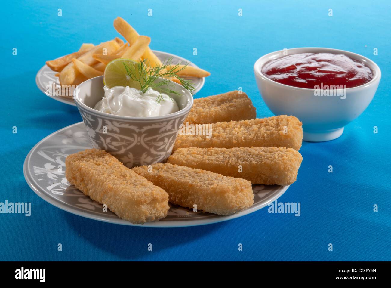 Fried Breaded fish fingers with chips and condiments Stock Photo - Alamy