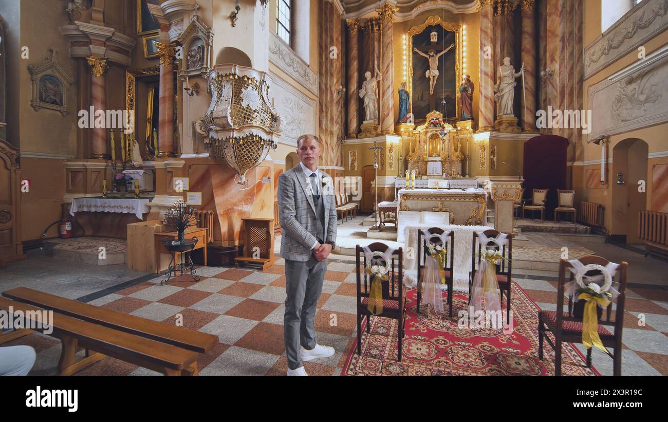 The groom is waiting for the bride in a Catholic church Stock Photo - Alamy