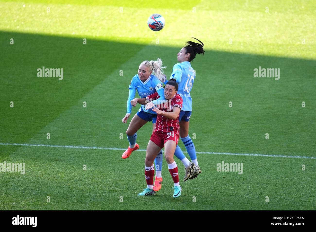 Bristol City's Ffion Morgan (centre) battles for the ball with ...
