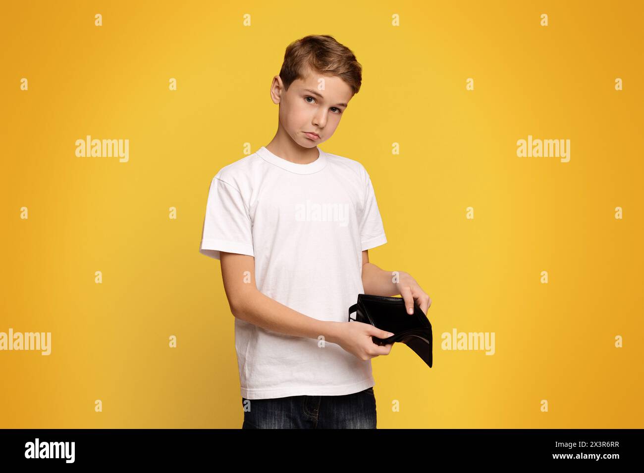 Sad teen boy showing old empty wallet Stock Photo - Alamy