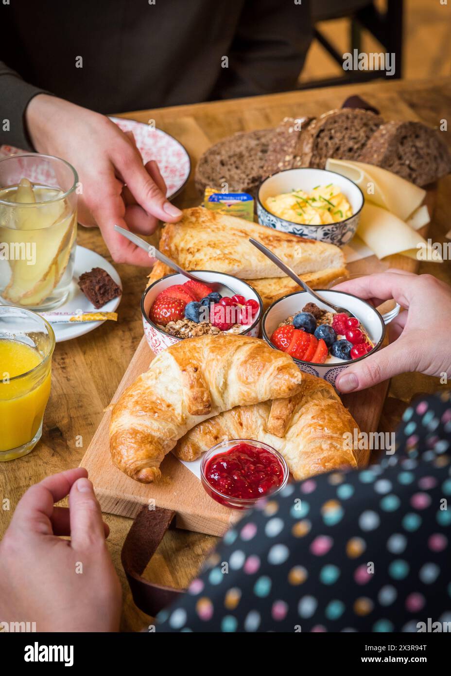 Breakfast of yogurt, fruit, croissants, bread, eggs and French toast ...