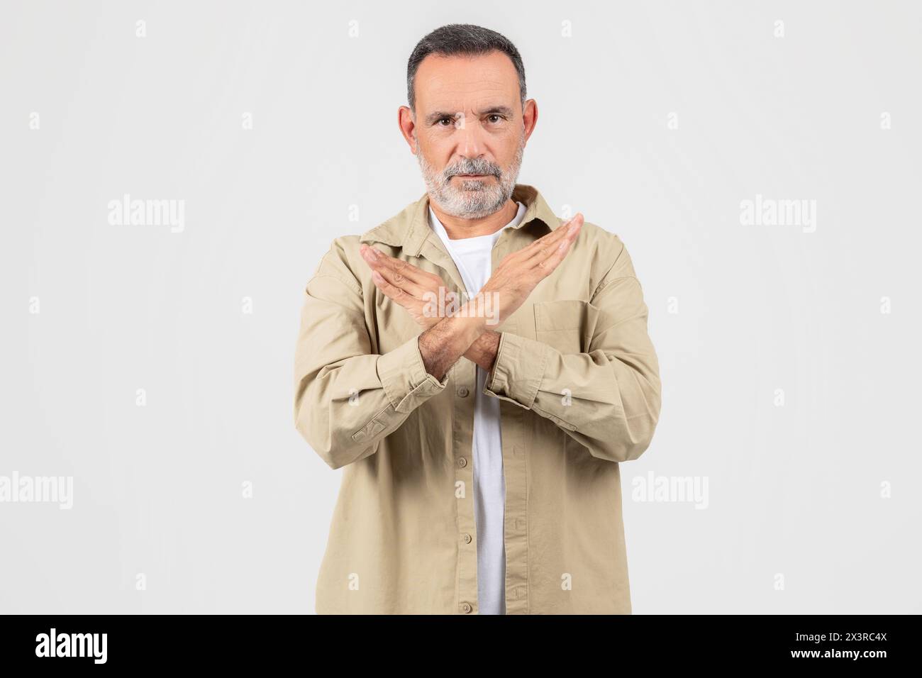Man Standing With Hands Folded in Front of Chest Stock Photo - Alamy