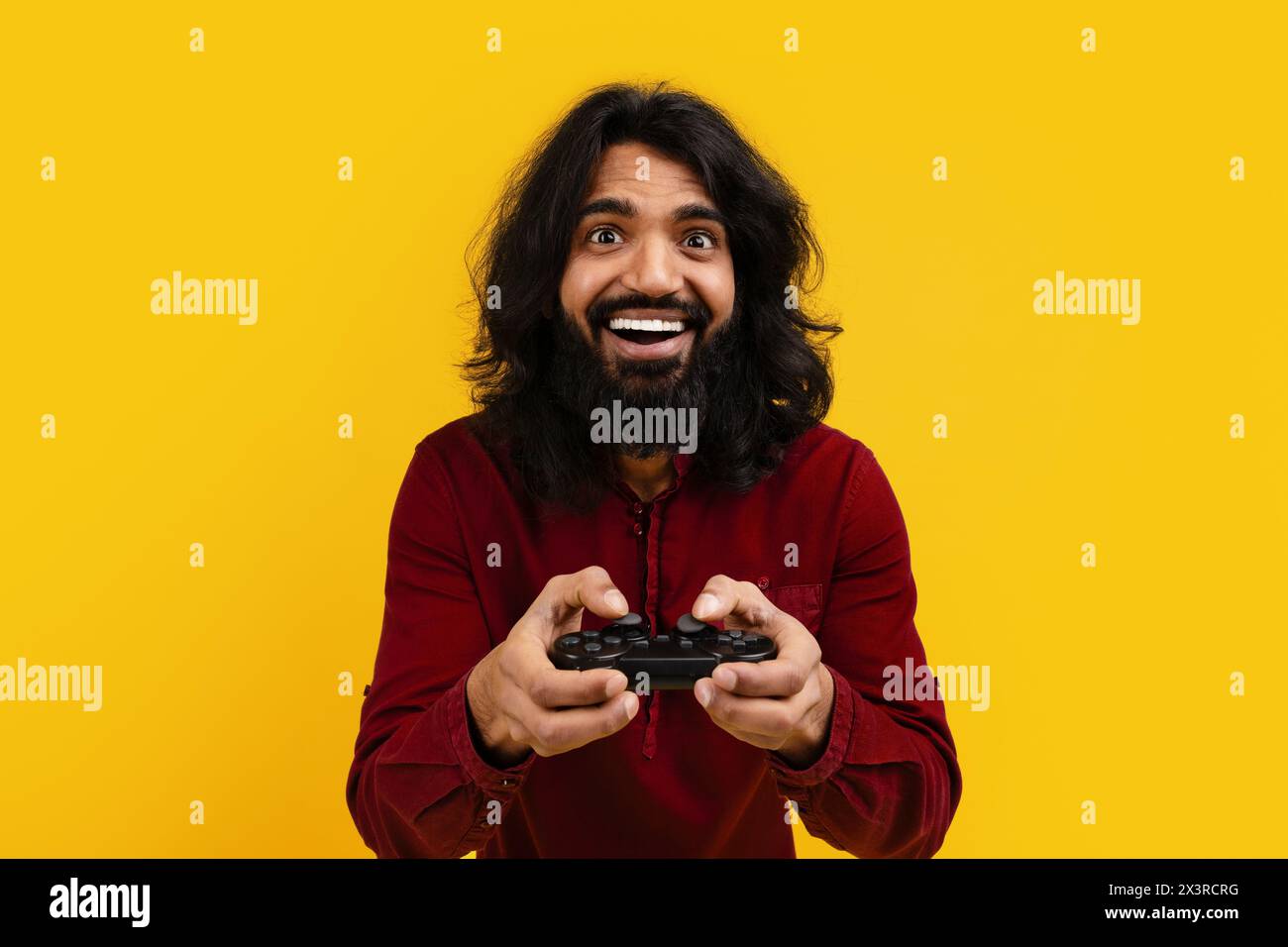 Man Holding Video Game Controller on Yellow Background Stock Photo - Alamy