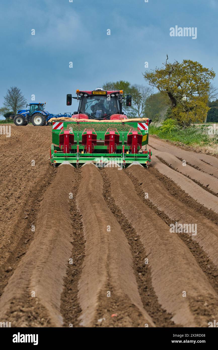 Tractor's carrying out deep bed drilling, preparing for potato planting ...