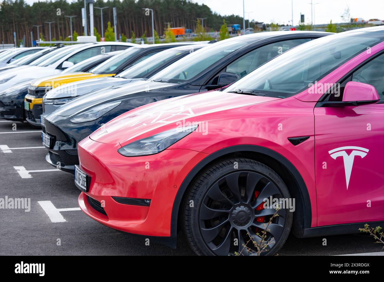 Many Tesla electric cars on street parking lot, Automotive industry in ...