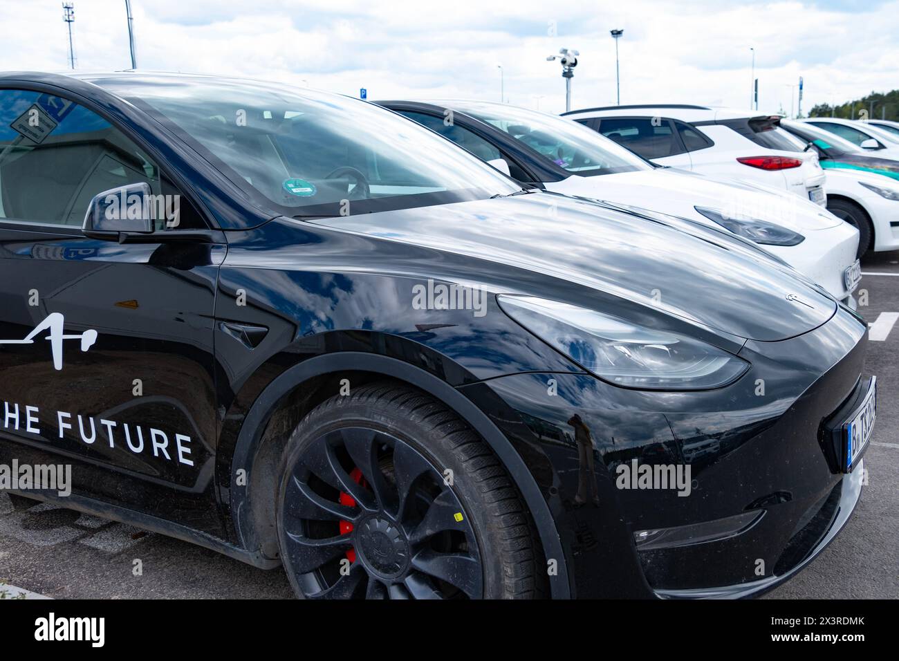 Many Tesla electric cars on street parking lot, Automotive industry in ...