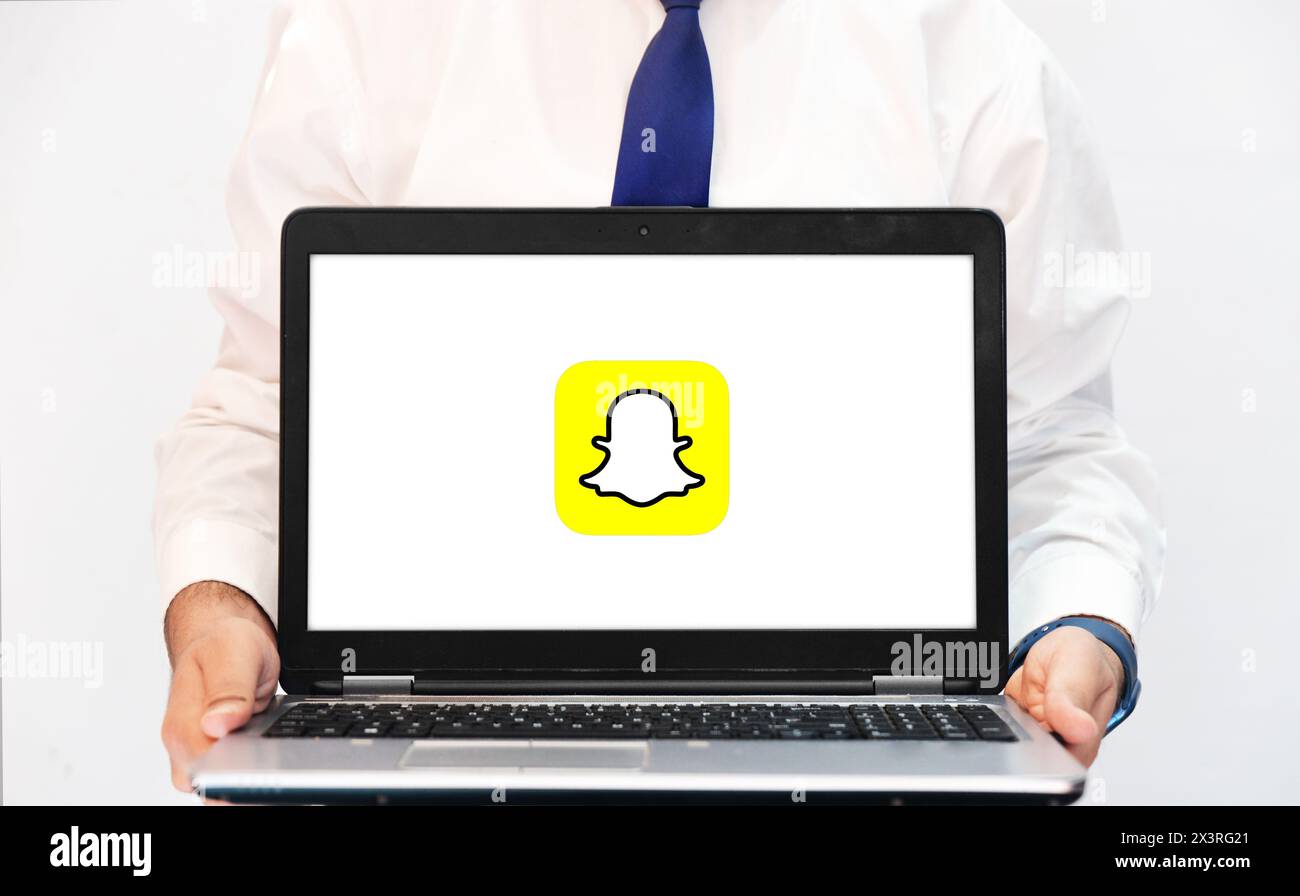 Snapchat Web version concept with laptop screen held by person on white ...