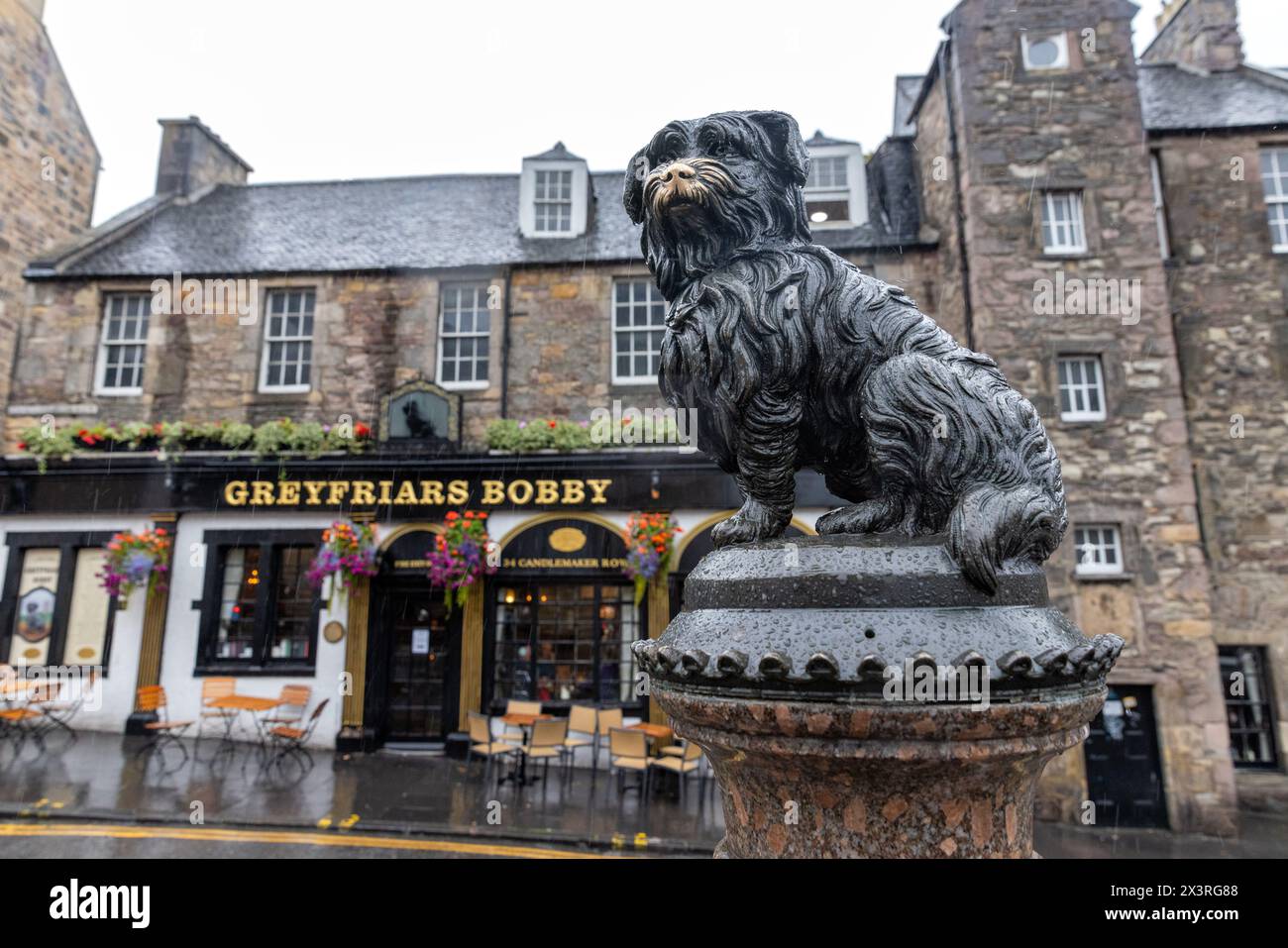 A statue of the dog Greyfriars Bobby outside the pub bearing his name ...