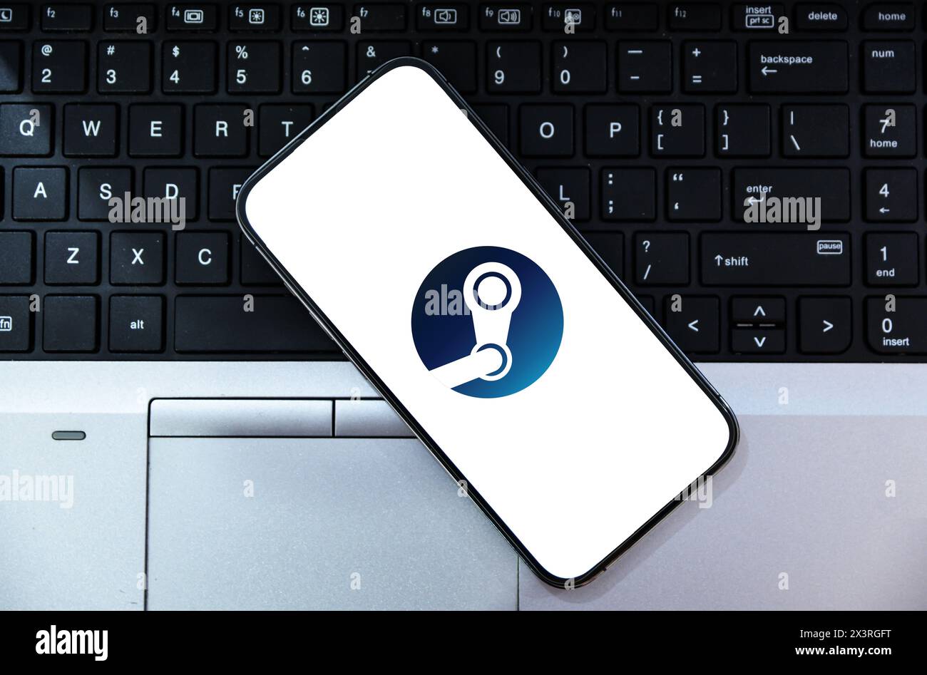 Steam Gaming engine on mobile screen with laptop keyboard in the ...