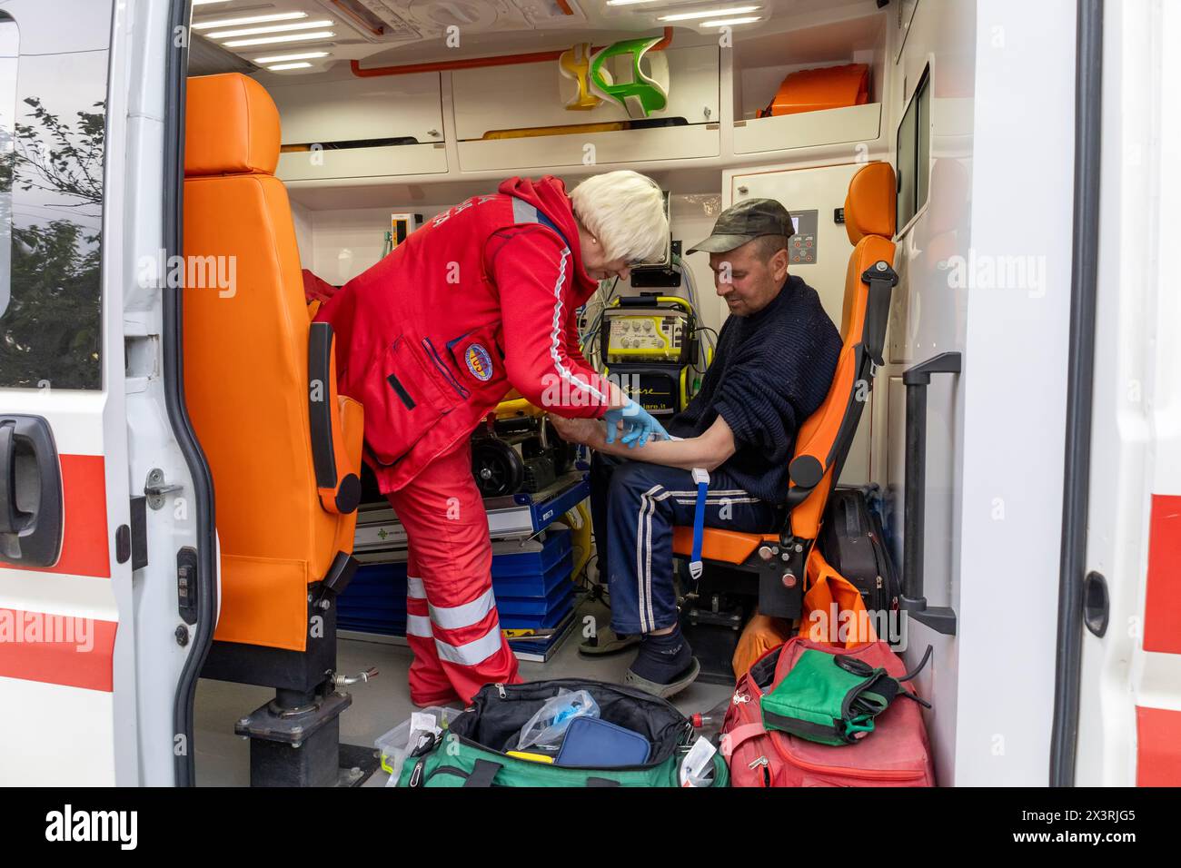 the paramedic gives an intravenous injection to the patient Stock Photo ...