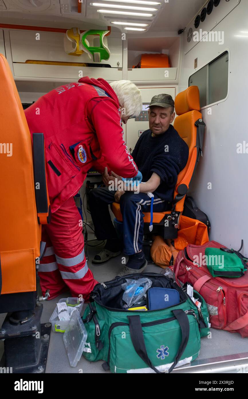 the paramedic gives an intravenous injection to the patient Stock Photo ...