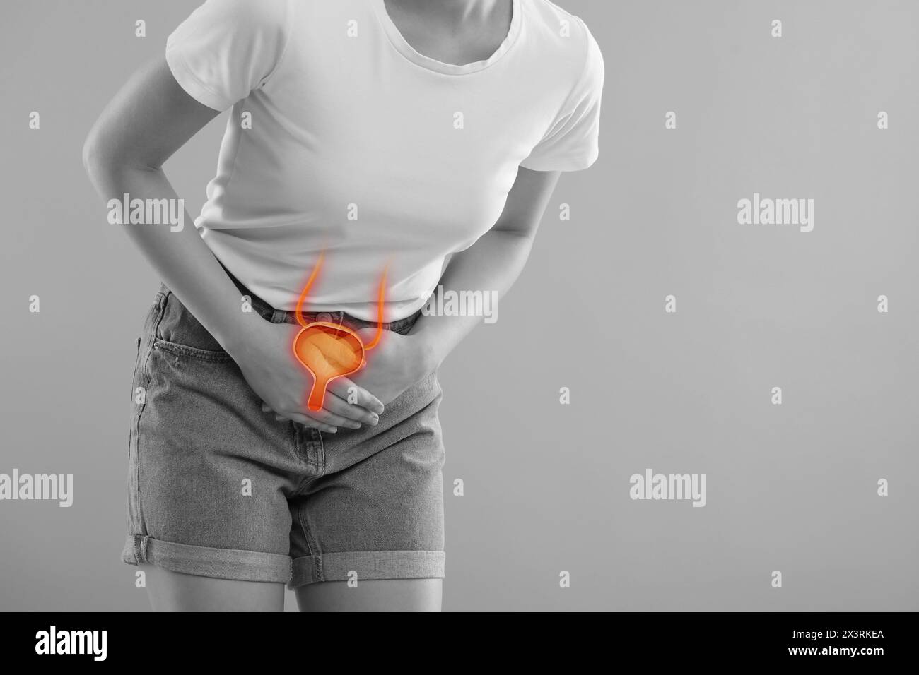 Woman suffering from cystitis on light grey background, closeup ...