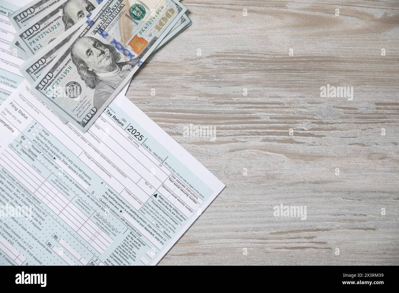Payroll. Tax return forms and dollar banknotes on wooden table, flat ...