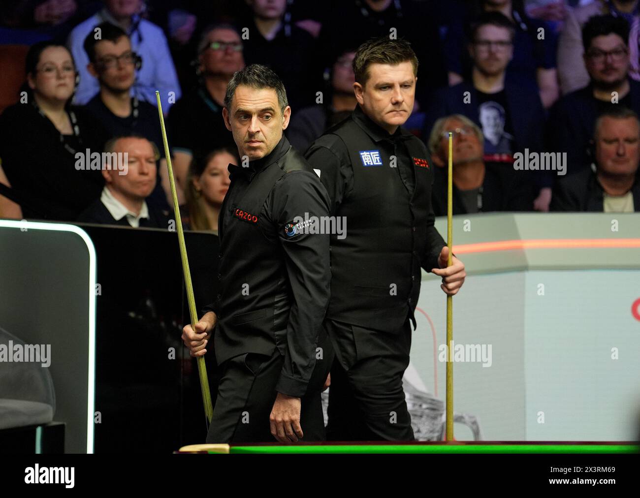 Ronnie O'Sullivan (left) and Ryan Day look at the table during their ...