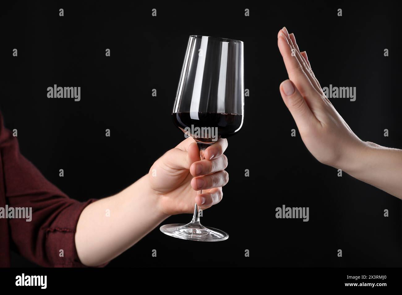 Alcohol addiction. Woman refusing glass of wine on black background ...
