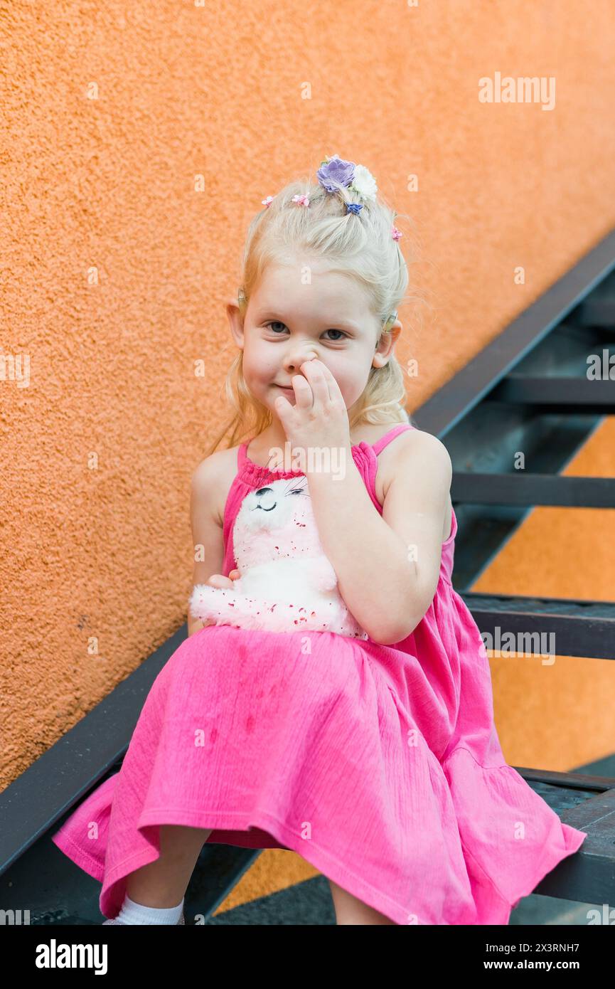 Child girl walks and have fun outdoor with cochlear implant on the head ...