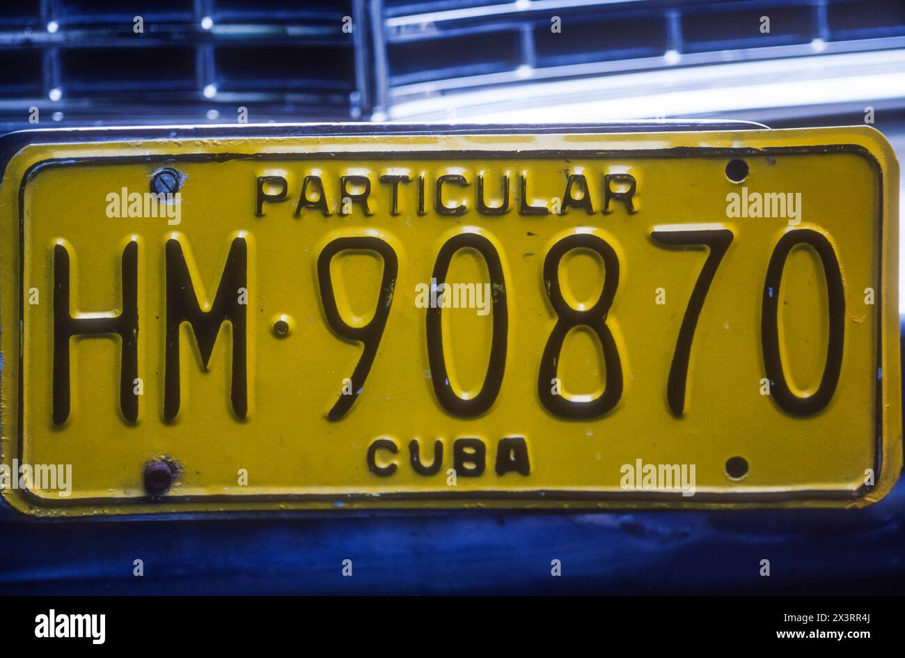 Old style yellow number plate on a Cuban car in Havana. The word ...