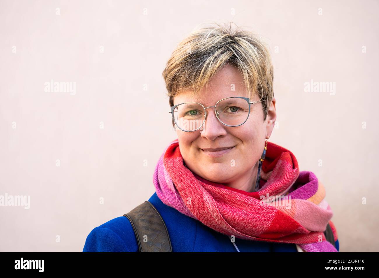 Colorful portrait of a 38 yo white woman with a salmon background ...