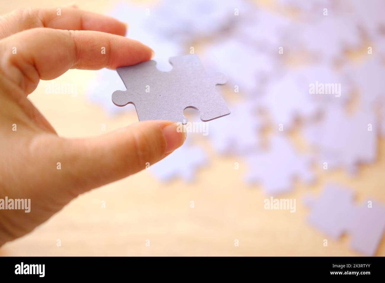 female hand holds cardboard puzzle piece, logical skills, puzzle ...