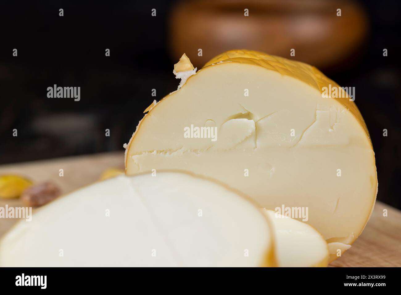 round processed cheese on the table, sausage cheese made from cow's ...